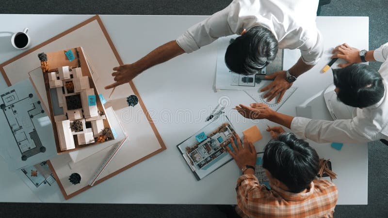 Group of Designer Look at Model while Discussing about Building ...