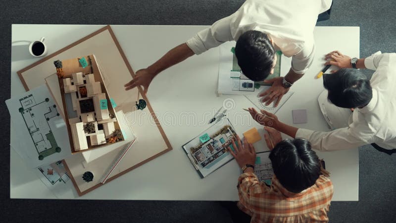Group of Designer Look at Model while Discussing about Building ...