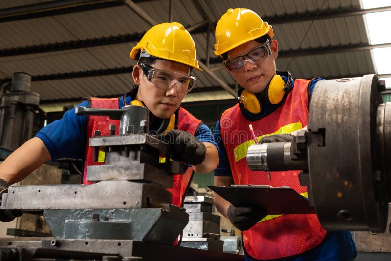 Group of Skillful Factory Workers Using Machine Equipment in Workshop ...