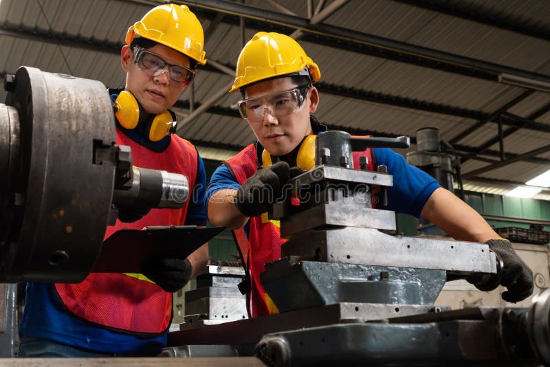 Group of Skillful Factory Workers Using Machine Equipment in Workshop ...