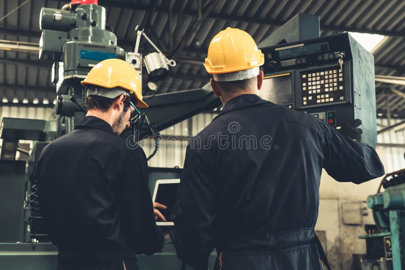 Group of Skillful Factory Workers Using Machine Equipment in Workshop ...