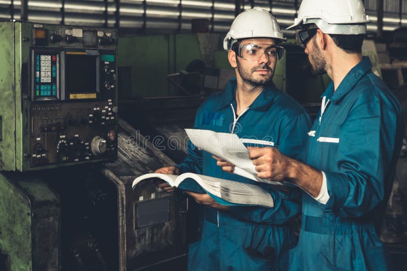 Group of Skillful Factory Workers Using Machine Equipment in Workshop ...