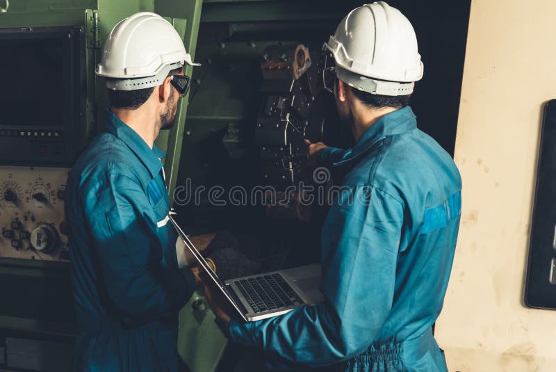 Group of Skillful Factory Workers Using Machine Equipment in Workshop ...
