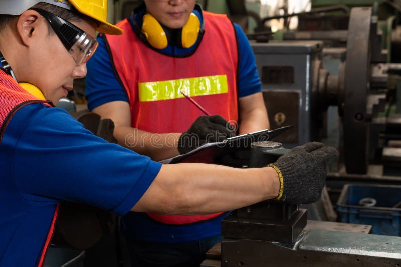 Group of Skillful Factory Workers Using Machine Equipment in Workshop ...