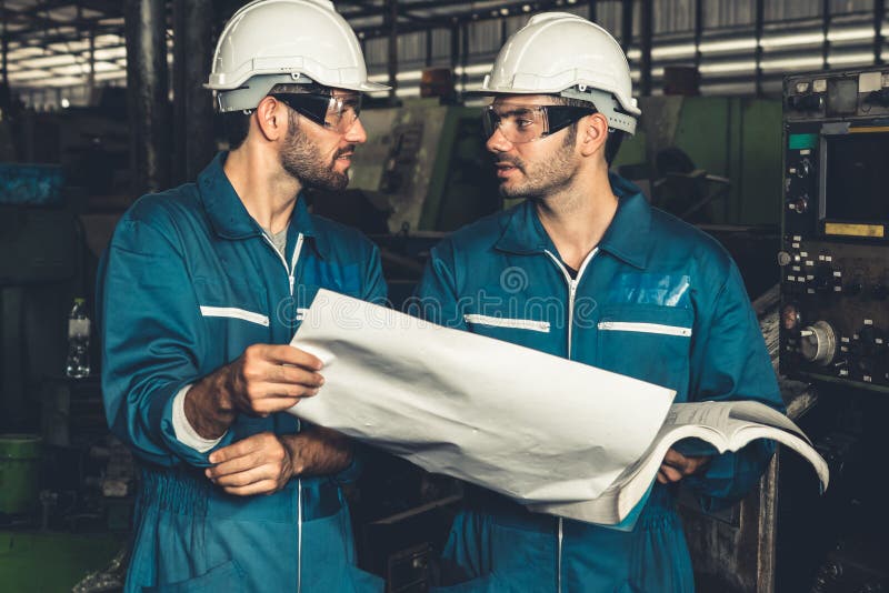 Group of Skillful Factory Workers Using Machine Equipment in Workshop ...