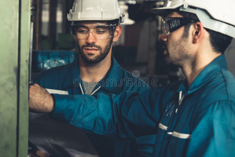 Group of Skillful Factory Workers Using Machine Equipment in Workshop ...