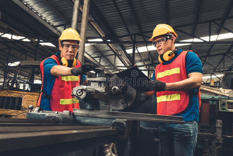 Group of Skillful Factory Workers Using Machine Equipment in Workshop ...