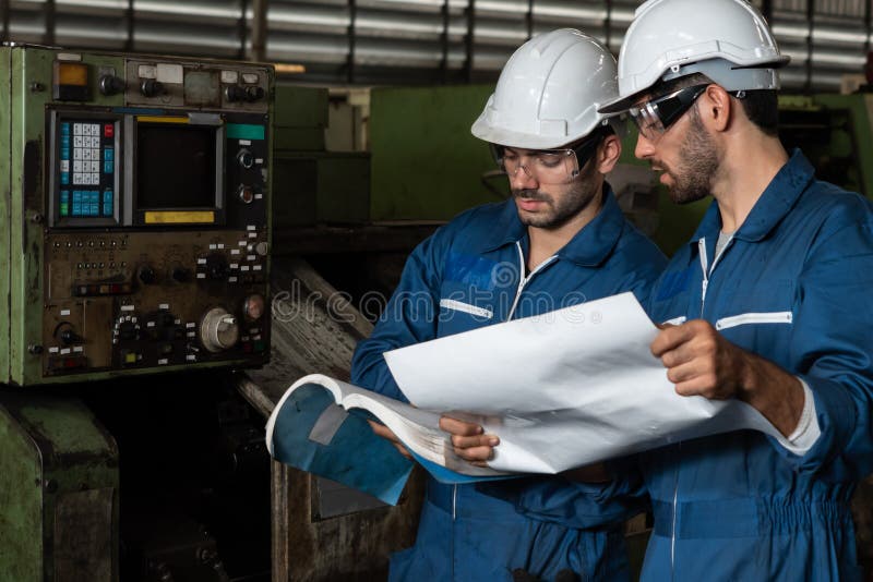 Group of Skillful Factory Workers Using Machine Equipment in Workshop ...