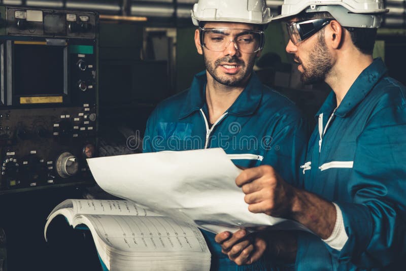 Group of Skillful Factory Workers Using Machine Equipment in Workshop ...