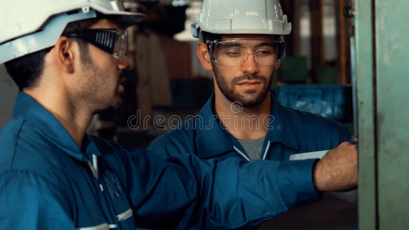 Group of Skillful Factory Workers Using Machine Equipment in Workshop ...