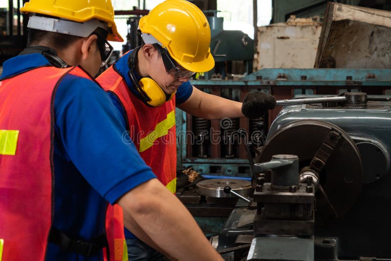 Group of Skillful Factory Workers Using Machine Equipment in Workshop ...