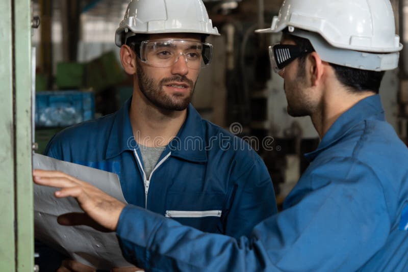 Group of Skillful Factory Workers Using Machine Equipment in Workshop ...