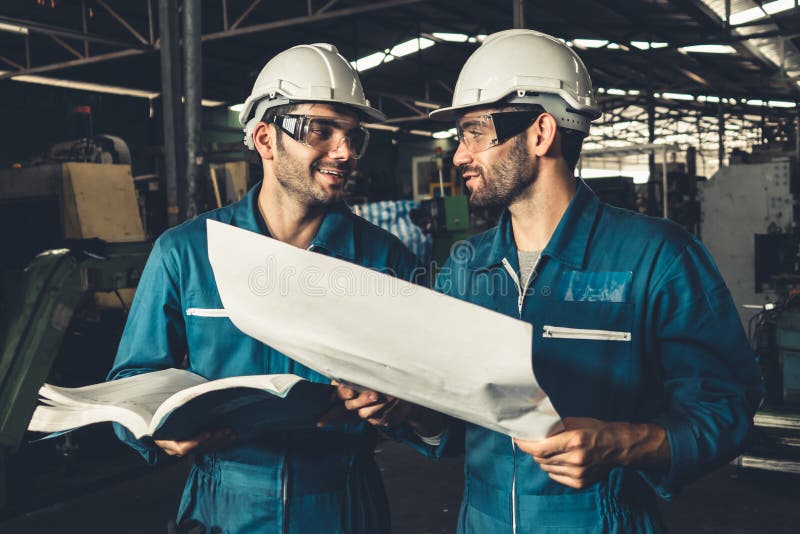 Group of Skillful Factory Workers Using Machine Equipment in Workshop ...