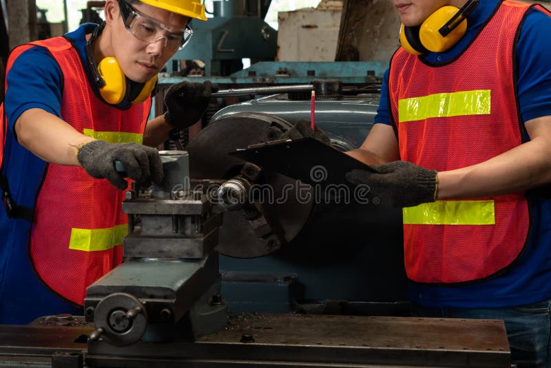 Group of Skillful Factory Workers Using Machine Equipment in Workshop ...
