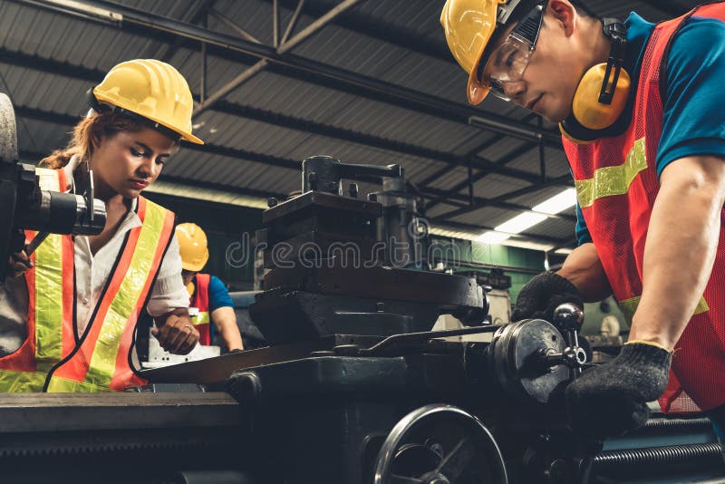Group of Skillful Workers Using Machine Equipment in Factory Workshop ...