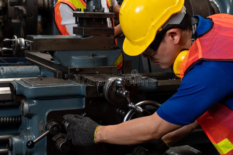 Group of Skillful Workers Using Machine Equipment in Factory Workshop ...