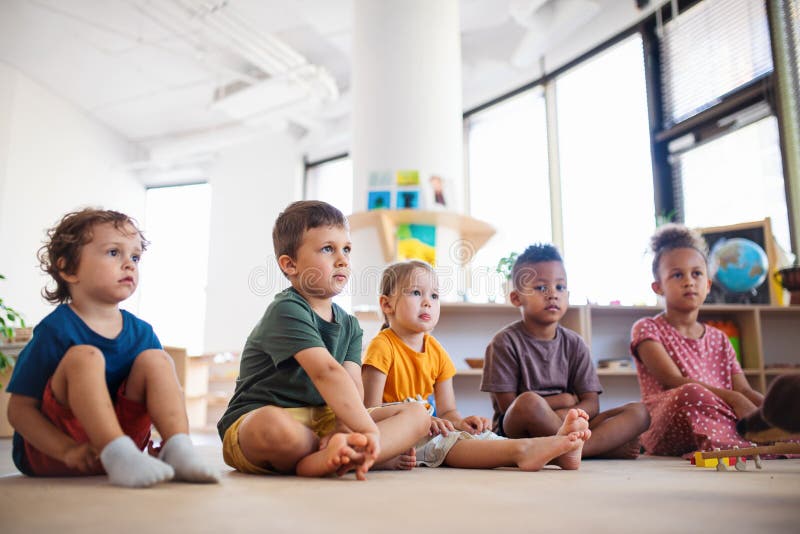 Group of Small Nursery School Children Sitting on Floor Indoors in ...