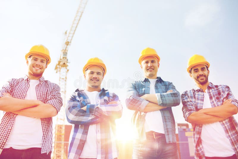 Group of Smiling Builders in Hardhats Outdoors Stock Image - Image of ...