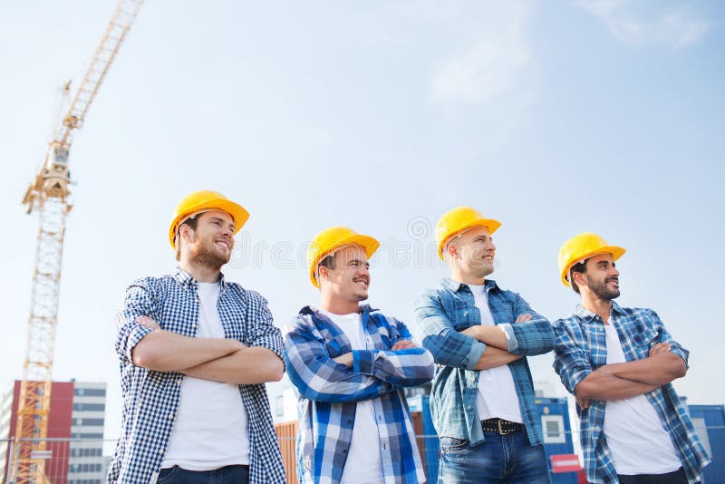 Group of Smiling Builders in Hardhats Outdoors Stock Photo - Image of ...
