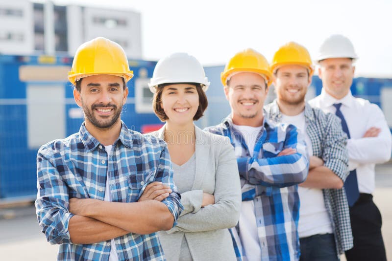 Group of Smiling Builders in Hardhats Outdoors Stock Image - Image of ...