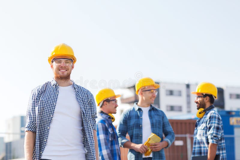 Group of Smiling Builders in Hardhats Outdoors Stock Photo - Image of ...