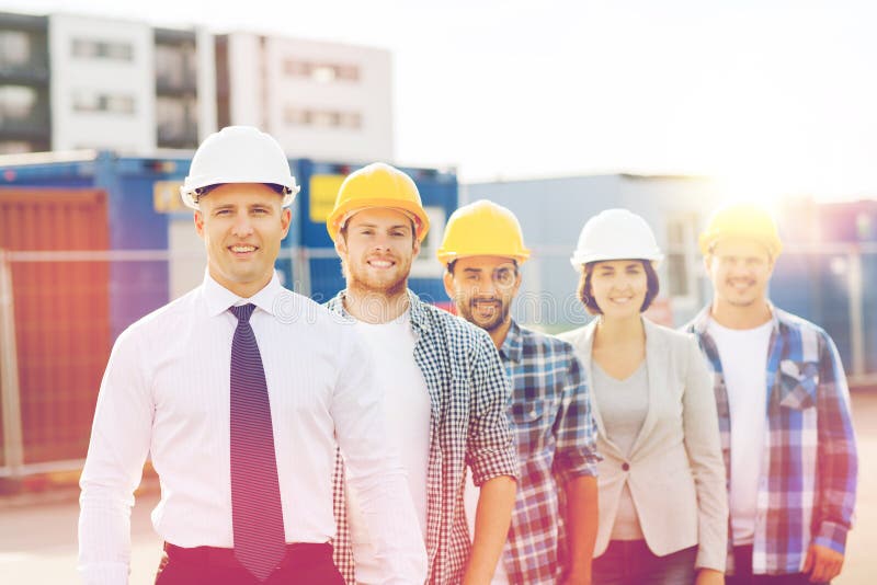 Group of Smiling Builders in Hardhats Outdoors Stock Photo - Image of ...