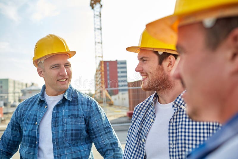 Group of Smiling Builders in Hardhats Outdoors Stock Image - Image of ...