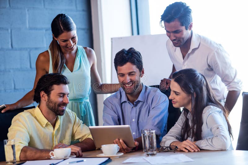 Group of Smiling Coworkers Using a Laptop Stock Photo - Image of bureau ...