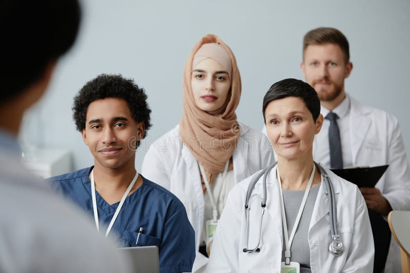 Group of Smiling Doctors in Audience at Conference Stock Photo - Image ... Group of Smiling Doctors in Audience at Conference Stock Photo - Image ...