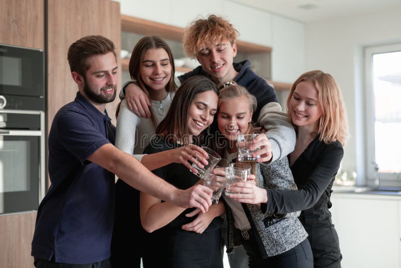 Group of Smiling Friends Having Drinks in the Kitchen Stock Photo ...