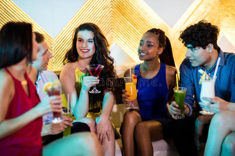 Group of Smiling Friends Interacting while Having Cocktail Stock Photo ...