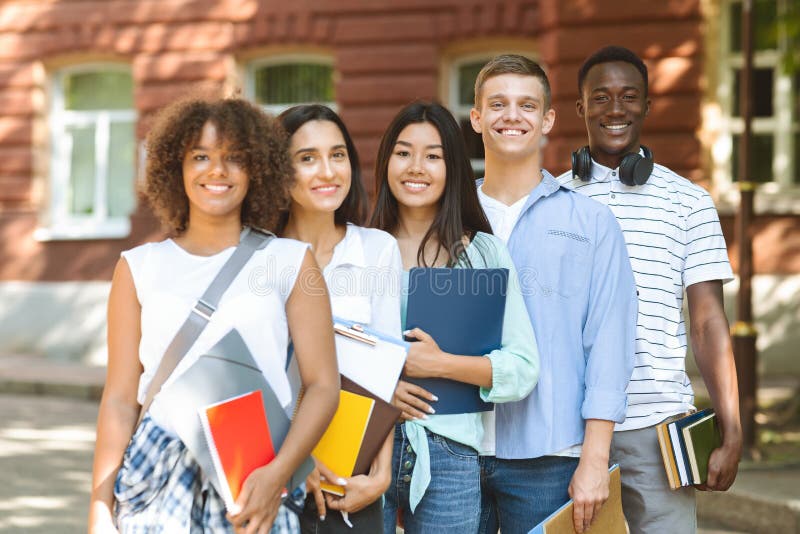 Group of Smiling Multicultural Students Posing Near University Campus ...