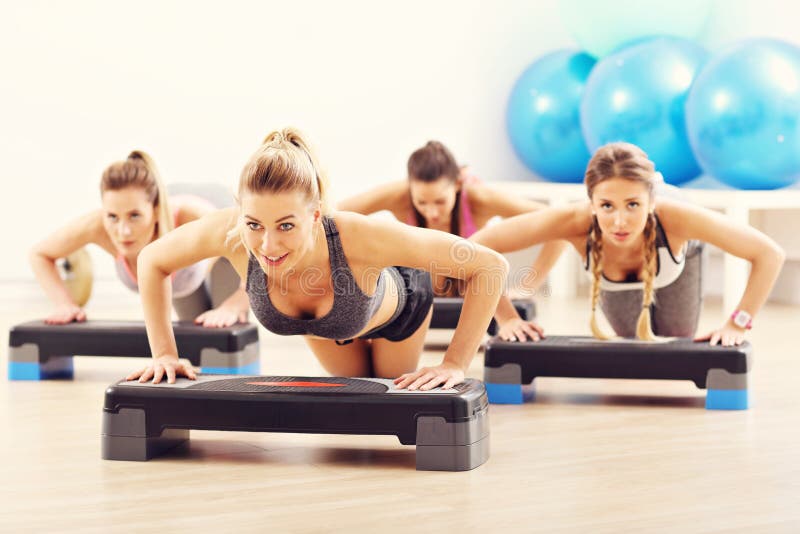 Group of Smiling People Doing Push-ups Stock Photo - Image of step ...