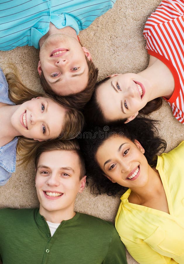 Group of Smiling People Lying Down on Floor Stock Photo - Image of ...