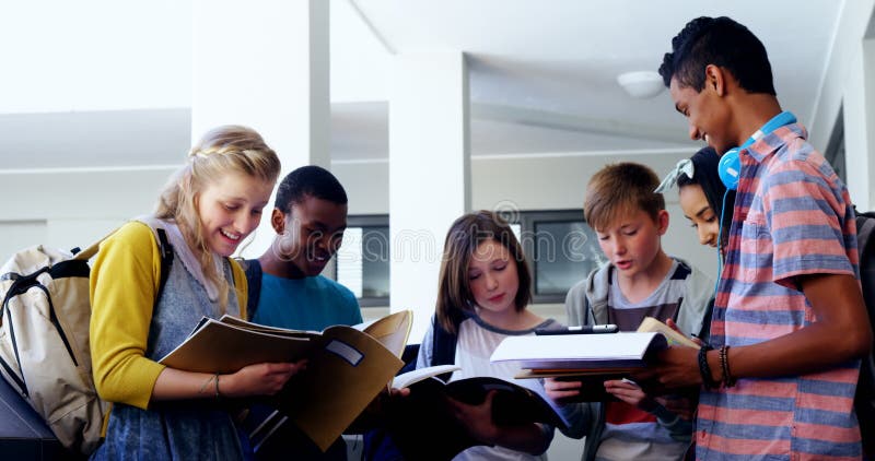 Group of Smiling Students Standing with Notebook in Corridor Stock ...