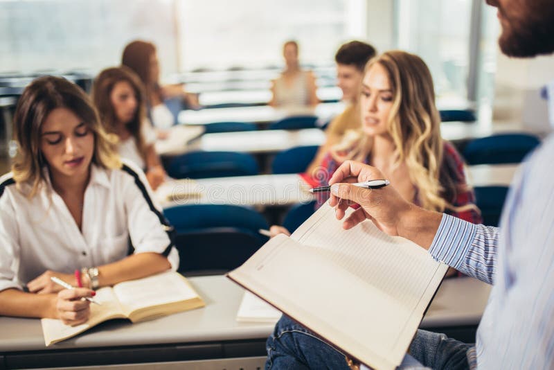 Smiling Students and Teacher with Notebook in Classroom Stock Image ...