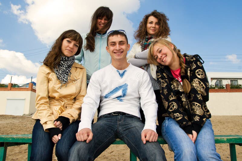 Group of Smiling Young People on a Bench Stock Photo - Image of colors ...