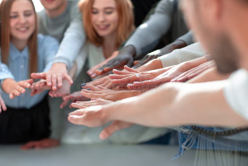 Group of Smiling Young People Joining Their Hands Stock Image - Image ...