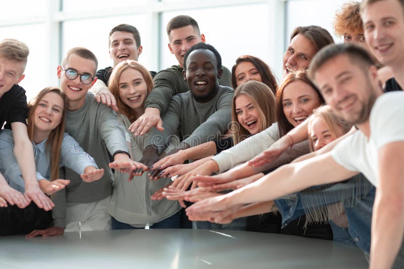 Group of Smiling Young People Joining Their Hands Stock Image - Image ...