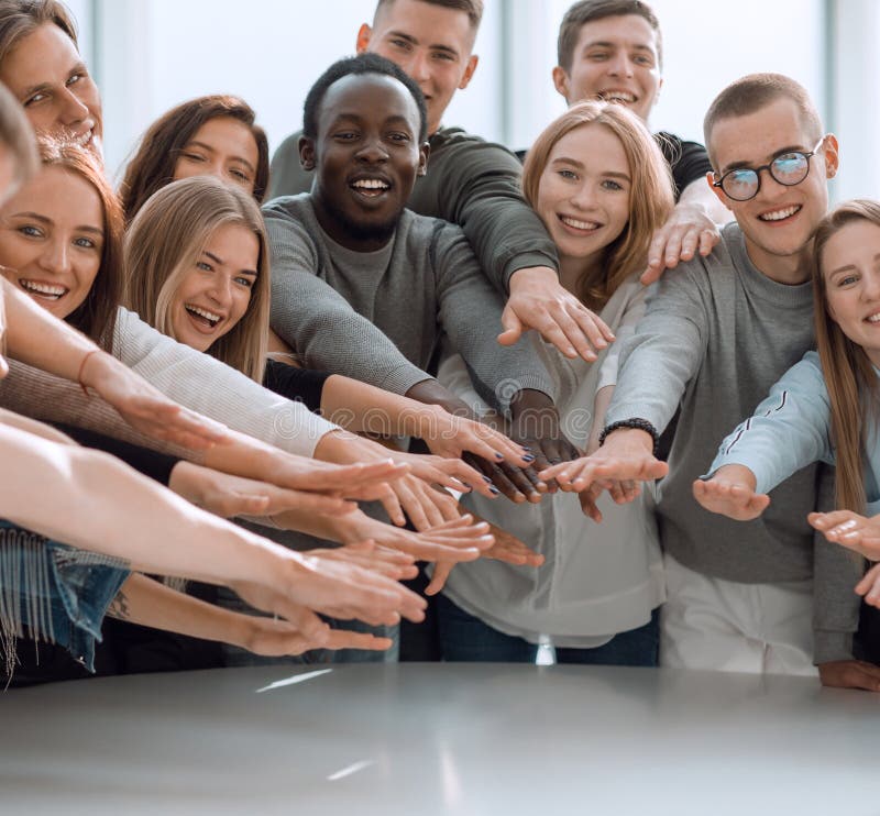 Group of Smiling Young People Joining Their Hands Stock Image - Image ...