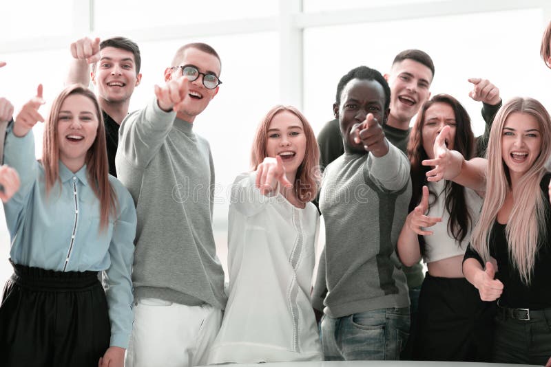 Group of Smiling Young People Pointing at One Point Stock Photo - Image ...