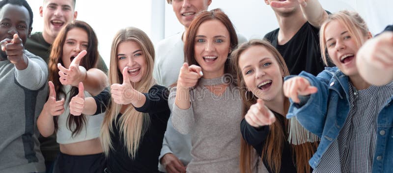 Group of Smiling Young People Pointing at One Point Stock Image - Image ...