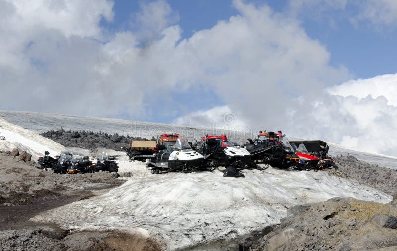 Group of Snowmobiles on a Mountain Slope in the Fall on a Glacier ...