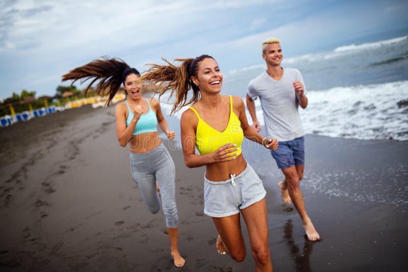 Group of Sport People Running on the Beach Stock Image - Image of male ...