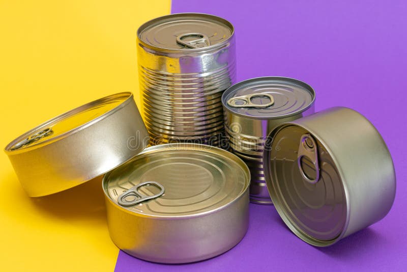 A Group of Stacked Tin Cans with Blank Edges on Split Yellow and Violet ...