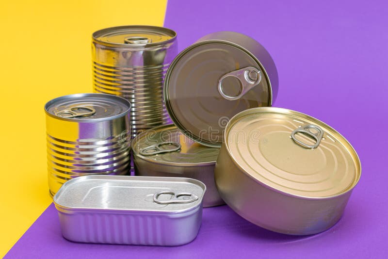 A Group of Stacked Tin Cans with Blank Edges on Split Yellow and Violet ...