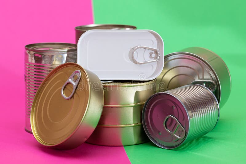 A Group of Stacked Tin Cans on Split Green and Cyan Background Stock ...