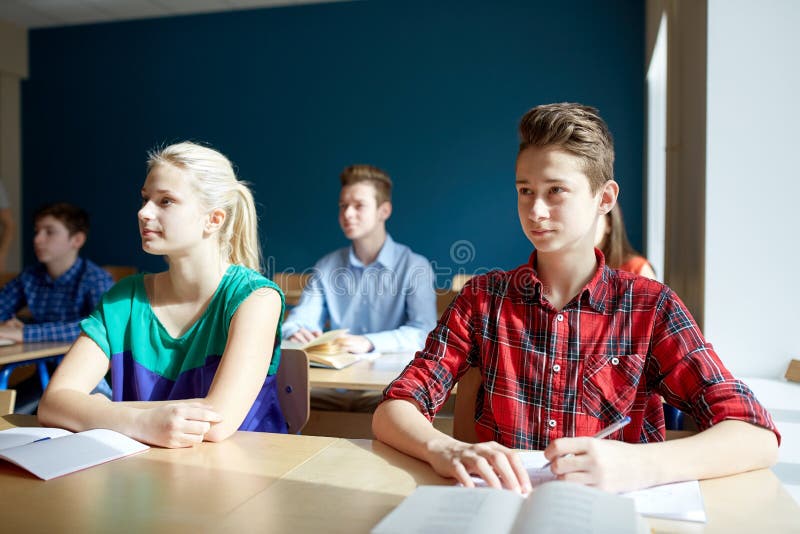 Group of students with books at school lesson - Stock Image - Everypixel