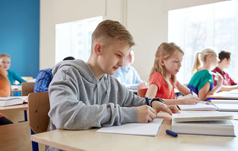 Group of School Kids Writing Test in Classroom Stock Photo - Image of ...