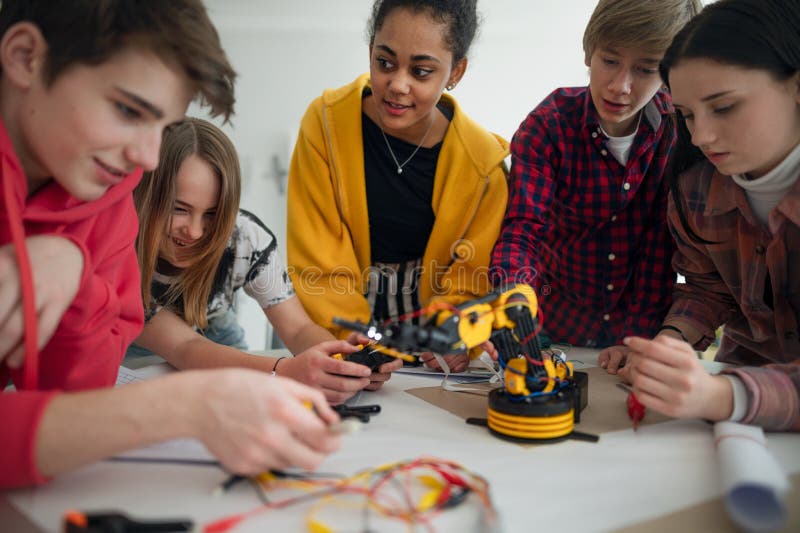 Group of Students Building and Programming Electric Toys and Robots at ...